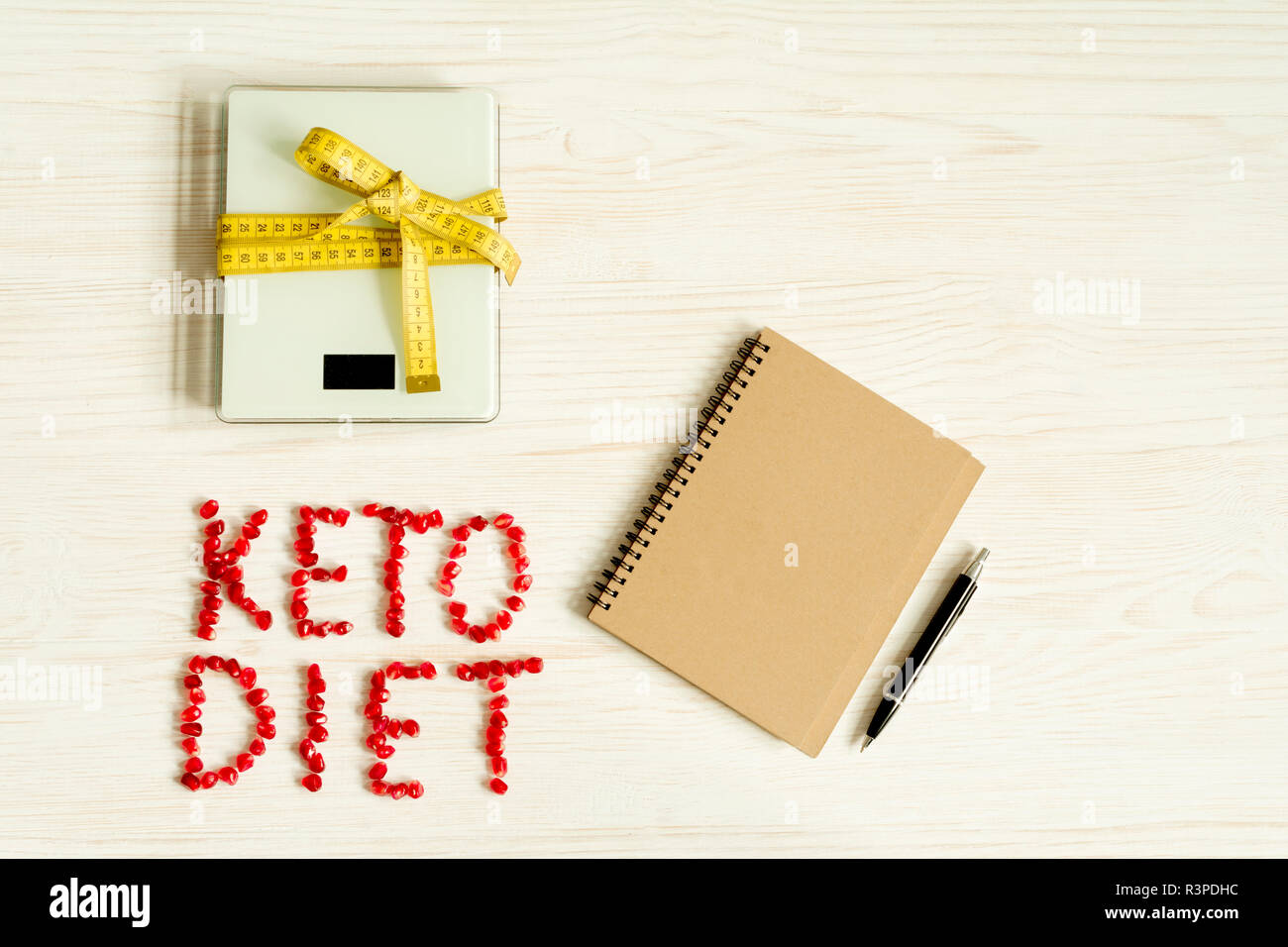 Ketogenic diet notes in the notebook on natural wood table. Concept of ...
