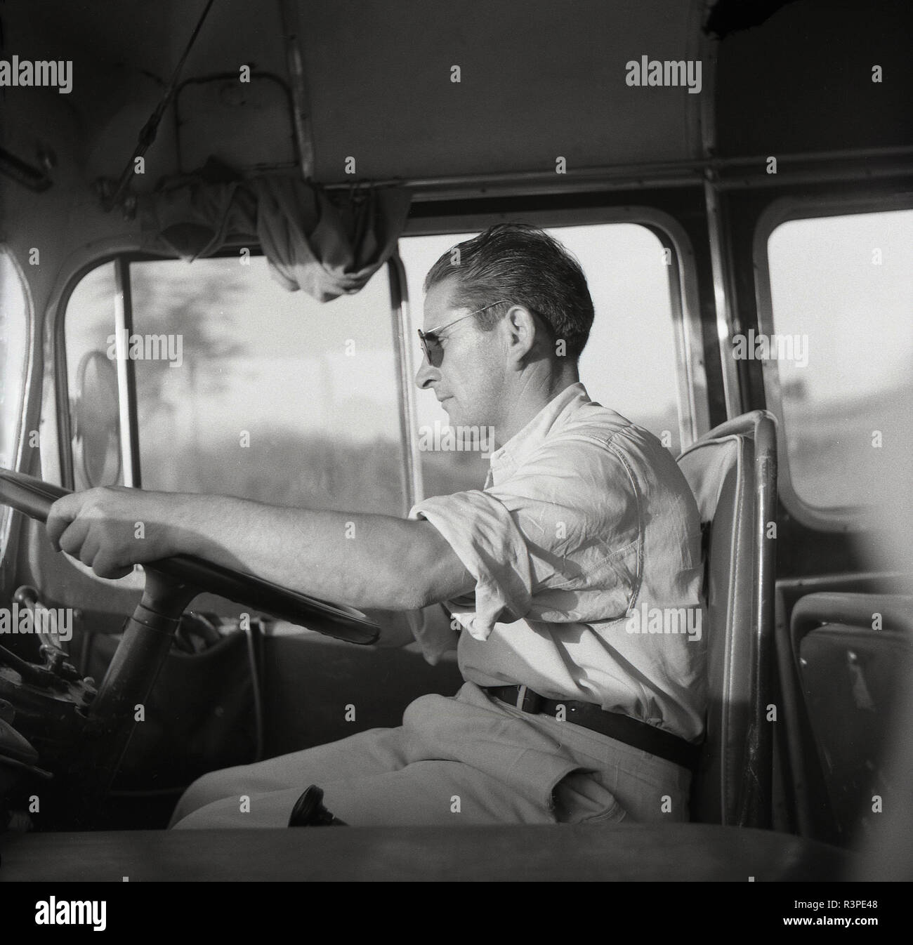 1950s, historical, a male coach driver sitting with his hands on ...