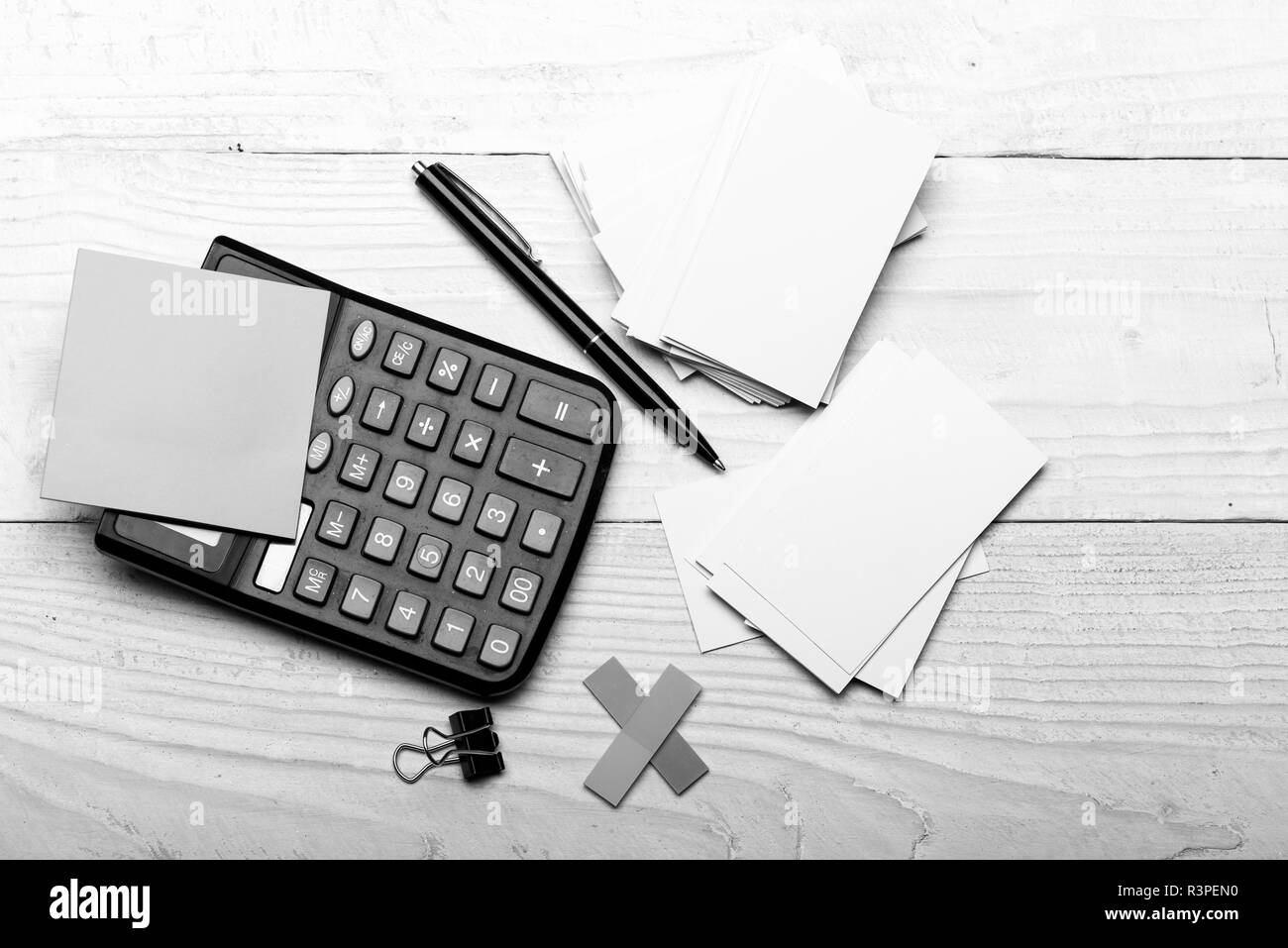 Stationery and calculator. Stickers in yellow color near pen on white ...