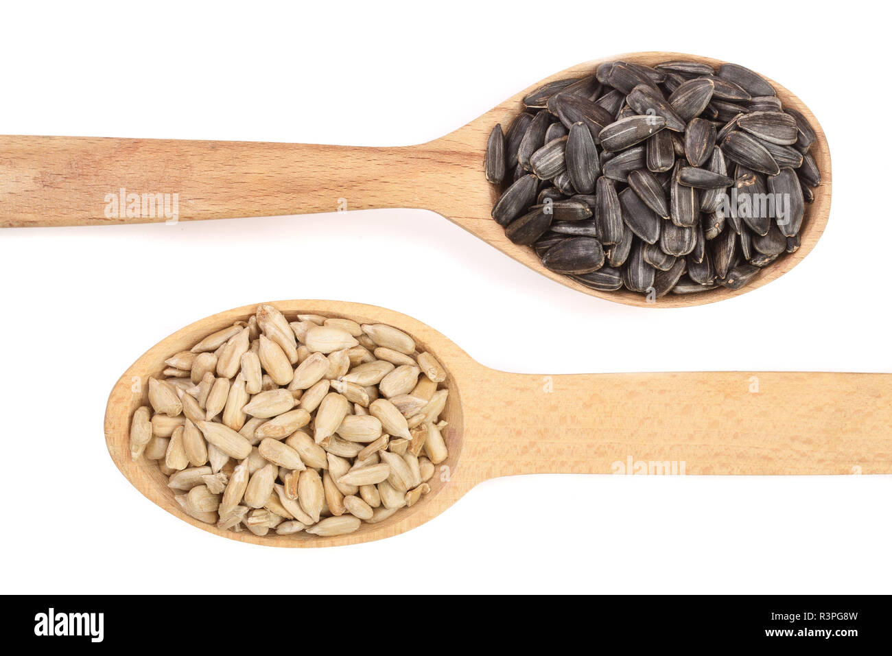 peeled and unpeeled seeds in a wooden spoon isolated on white ...