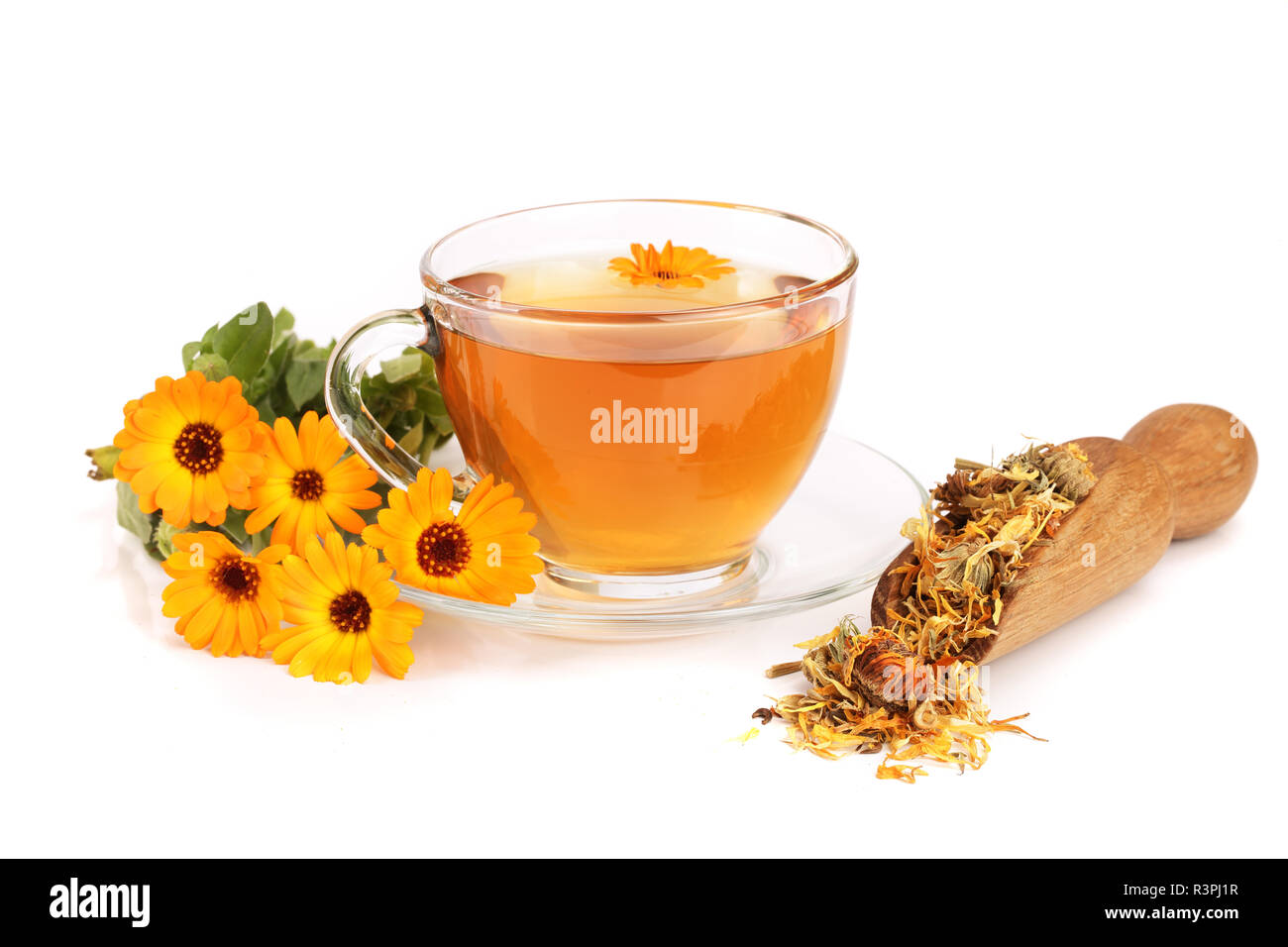 Calendula tea with fresh and dried flowers isolated on white background ...