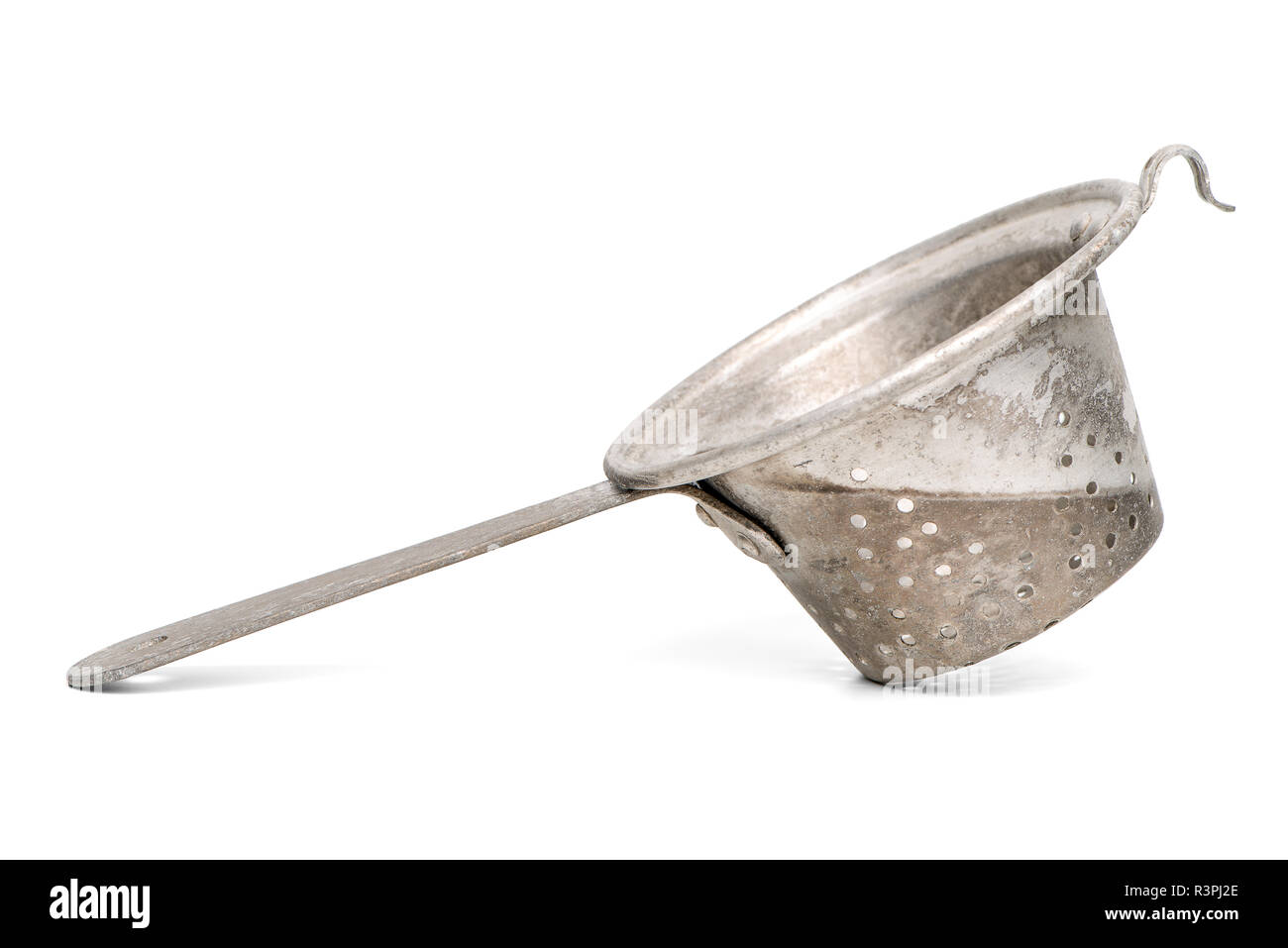 Old metal colander on white background Stock Photo - Alamy