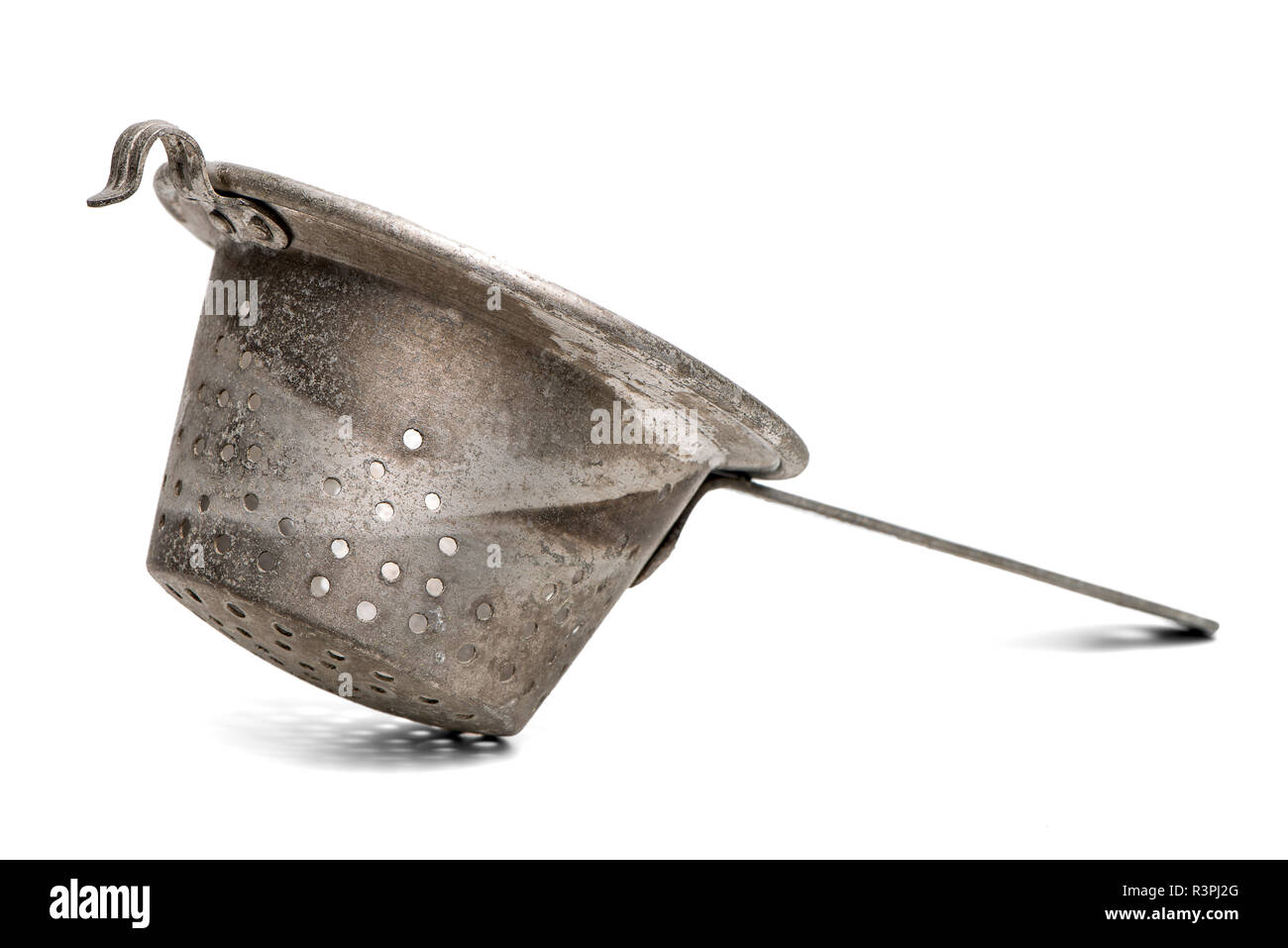 Old metal colander on white background Stock Photo - Alamy