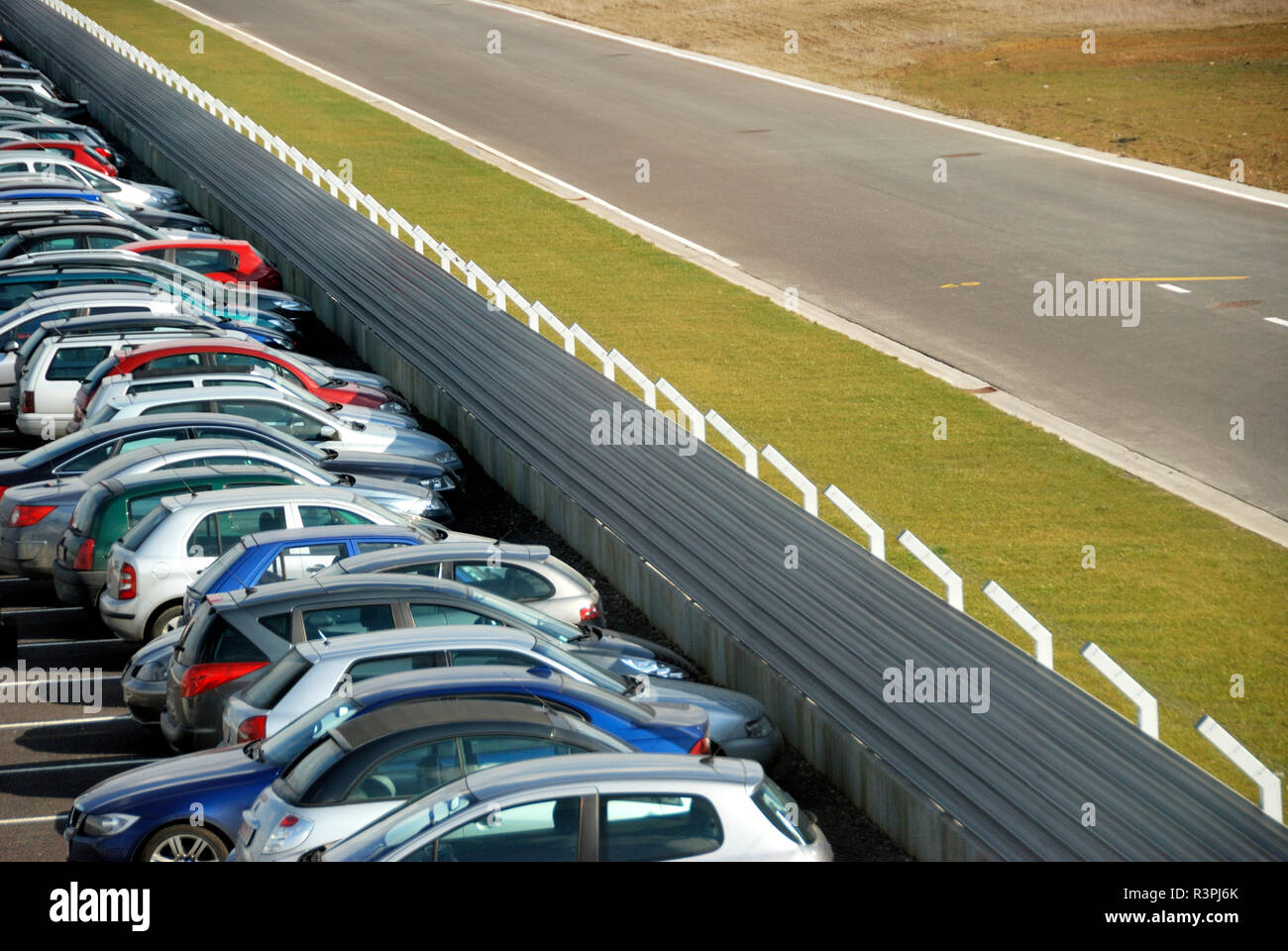Cars parked next to a landing strip Stock Photo - Alamy