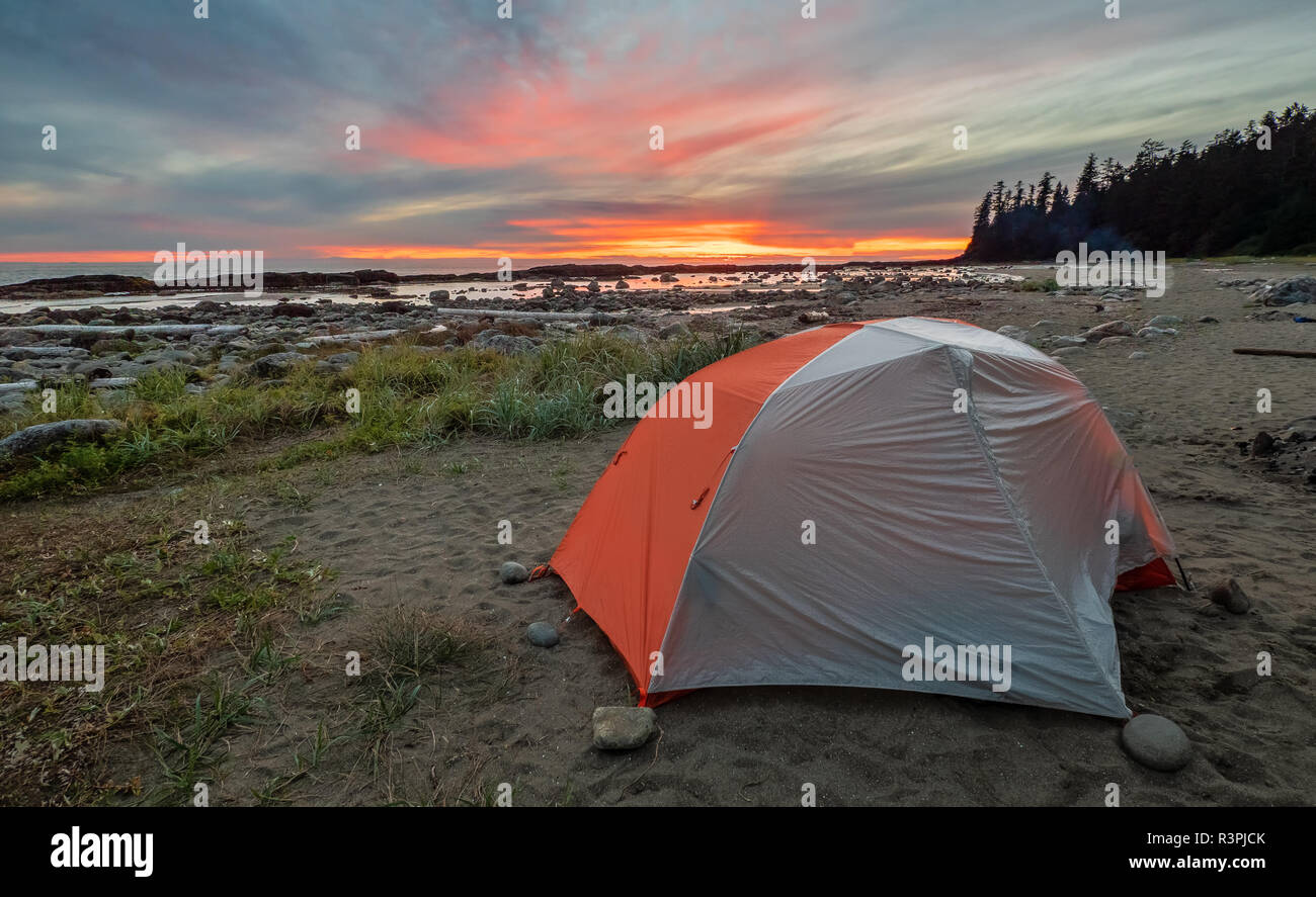 Backpacking tent on a beach with amazing dramatic sunrise in the ...