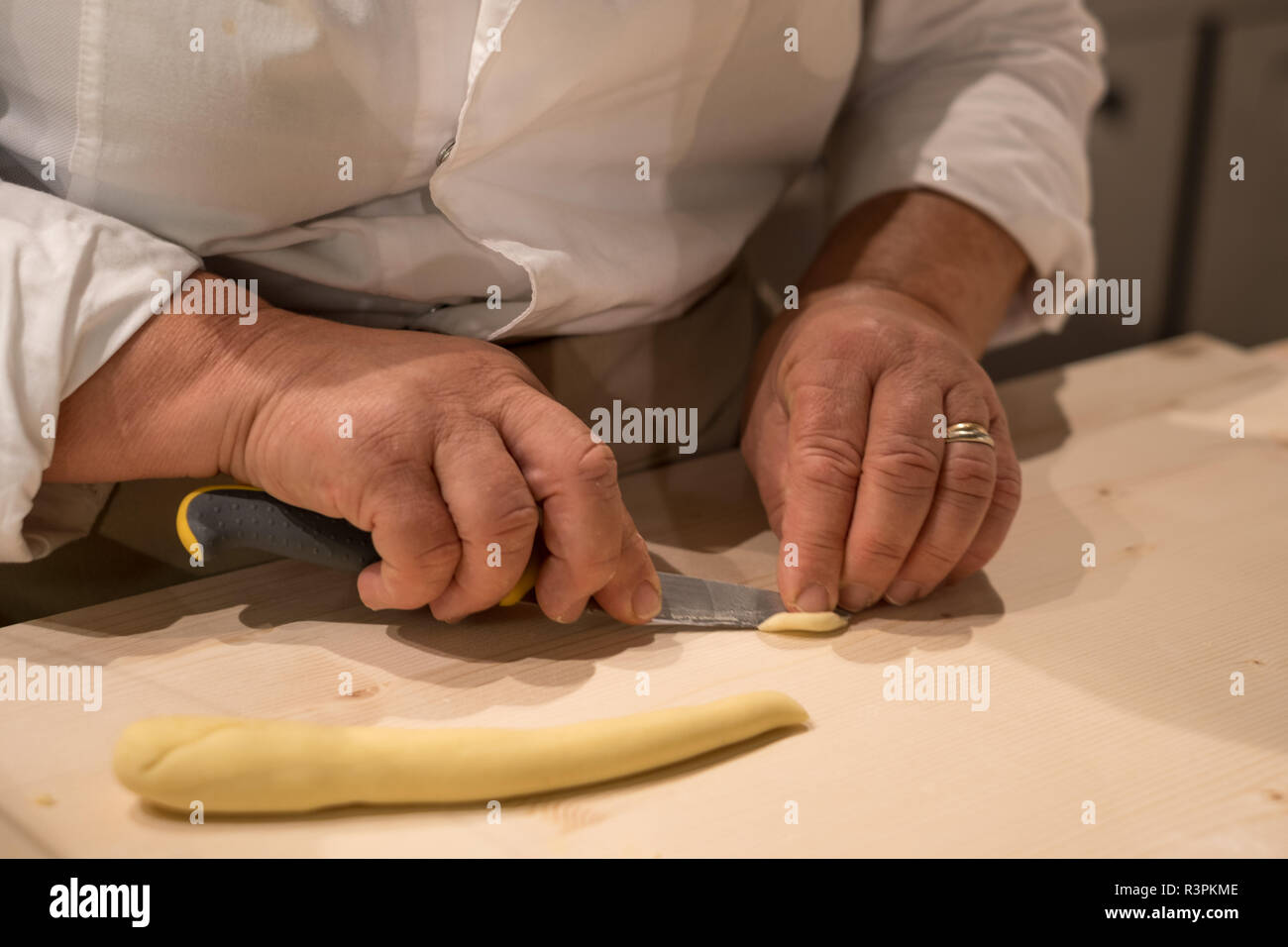 Close up of pasta making process. Woman makes orecchiette, ear shaped ...
