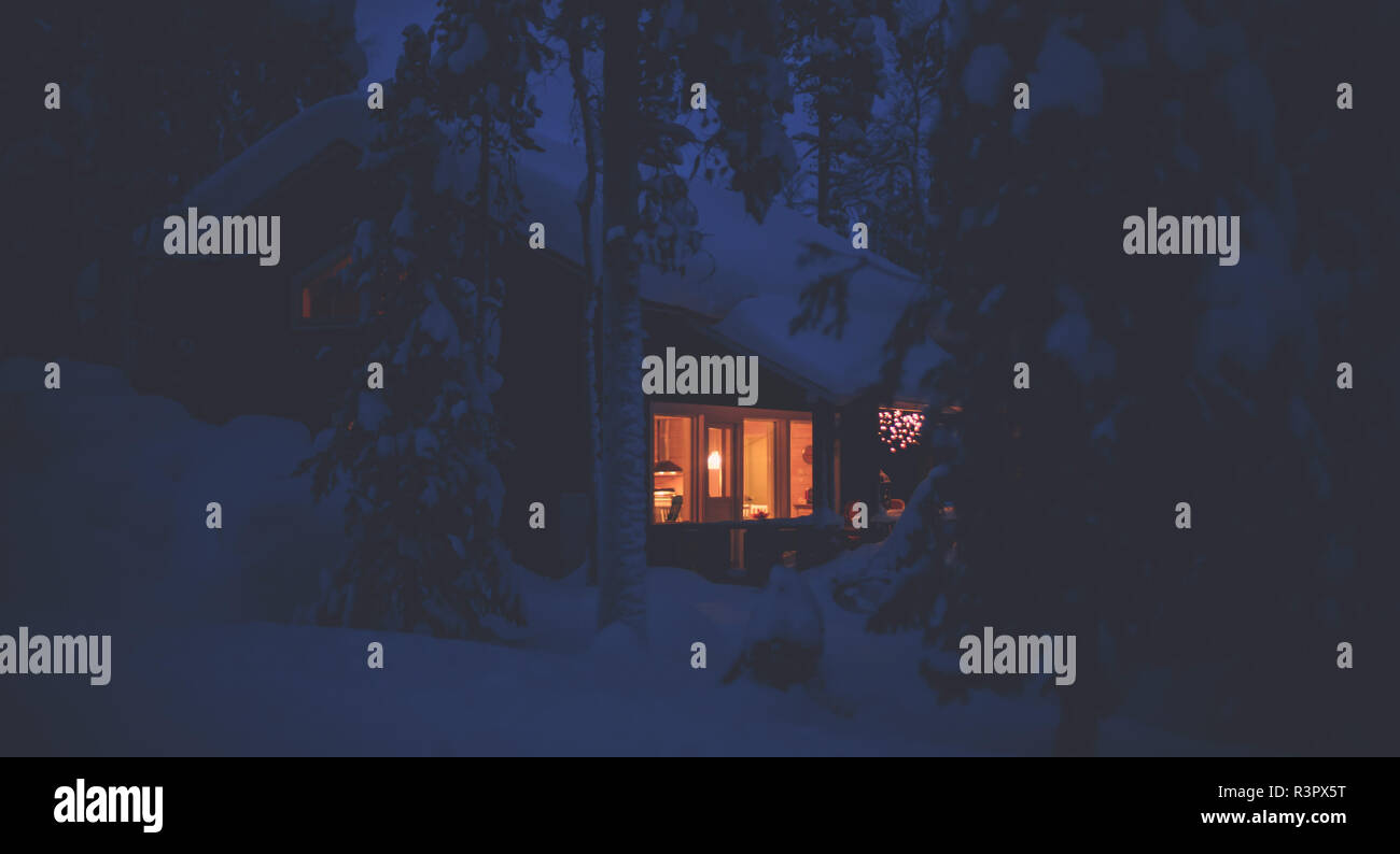 A night view of cozy wooden scandinavian cabin cottage chalet house ...