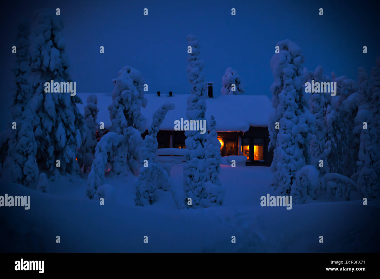 A cozy wooden cabin cottage chalet house covered in snow near ski ...