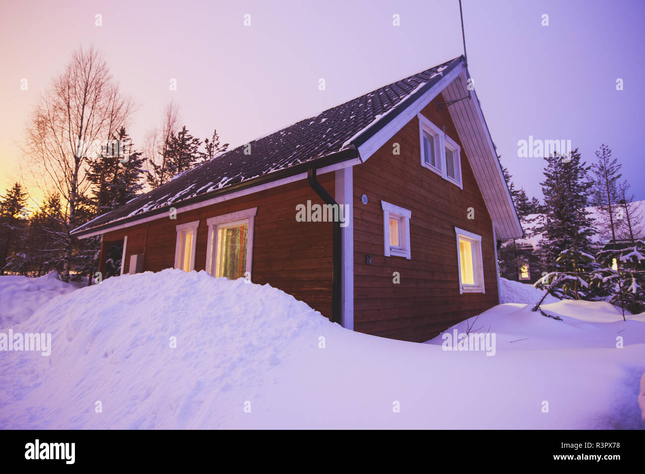 A cozy wooden cabin cottage chalet house covered in snow near ski ...