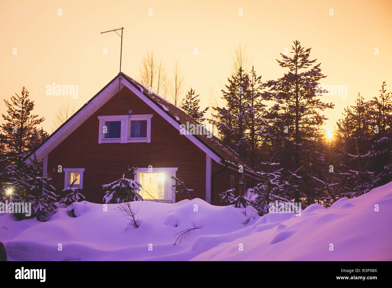 A cozy wooden cabin cottage chalet house covered in snow near ski ...
