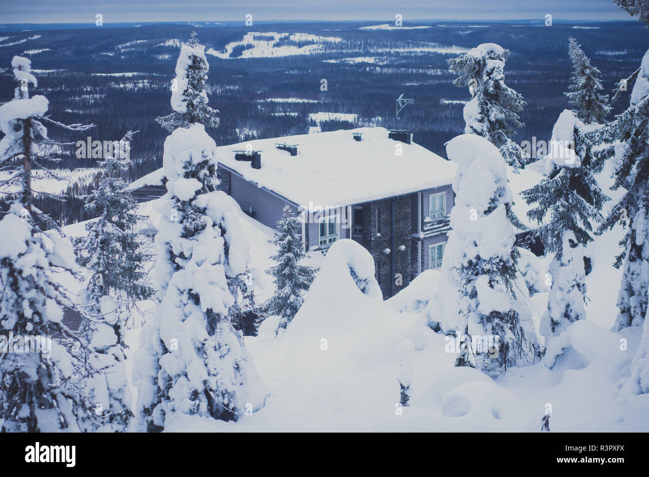 A cozy wooden cabin cottage chalet house covered in snow near ski ...