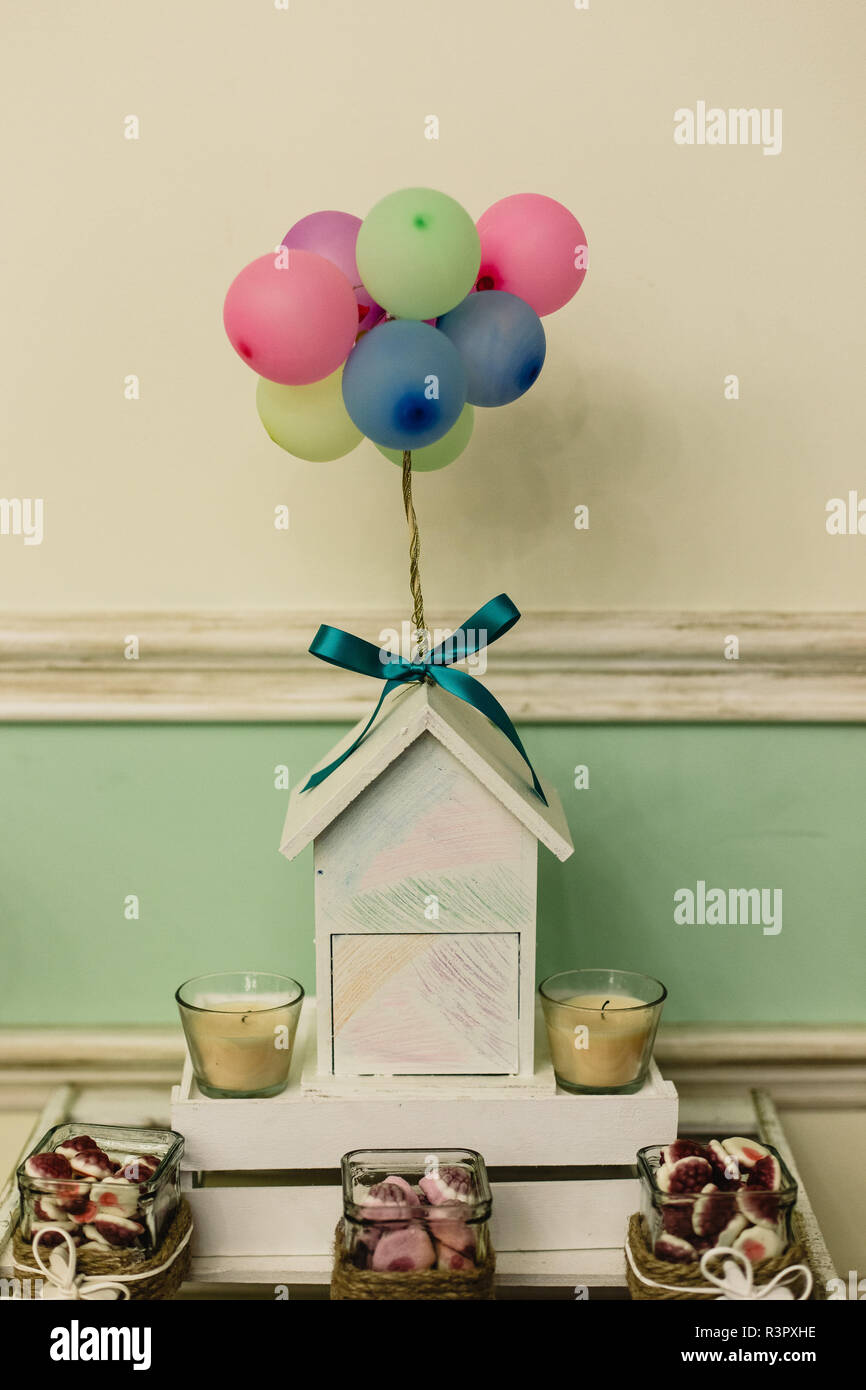 Wooden house with balloons on a birthday Stock Photo - Alamy