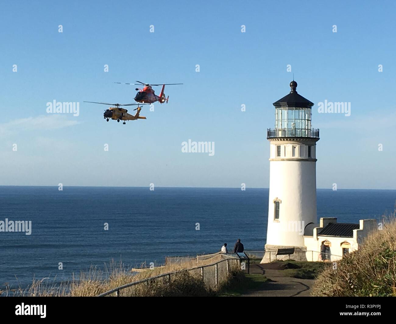 Aircrews aboard MH-65 Dolphin and MH-60 Jayhawk helicopters fly past ...