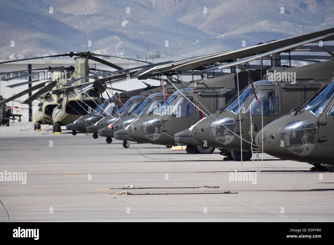 A line of UH-60 Black Hawks stands on the tarmac at Biggs Army Airfield ...