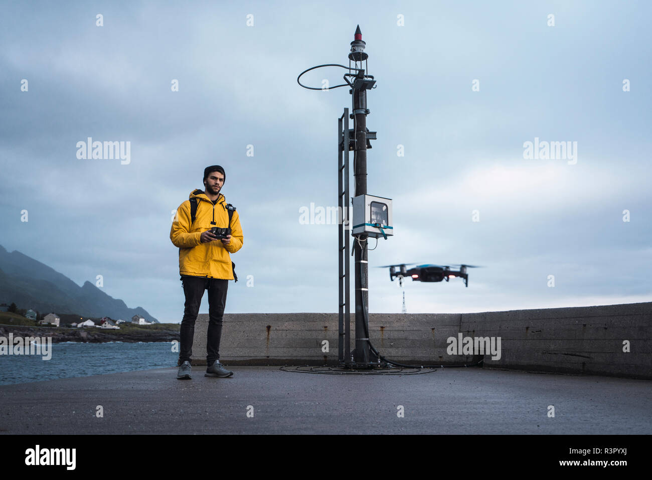 Man standing coast flying drone hi-res stock photography and images - Alamy