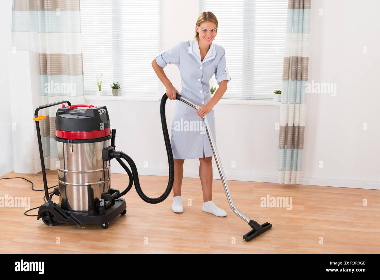 Female Maid With Vacuum Cleaner Stock Photo - Alamy