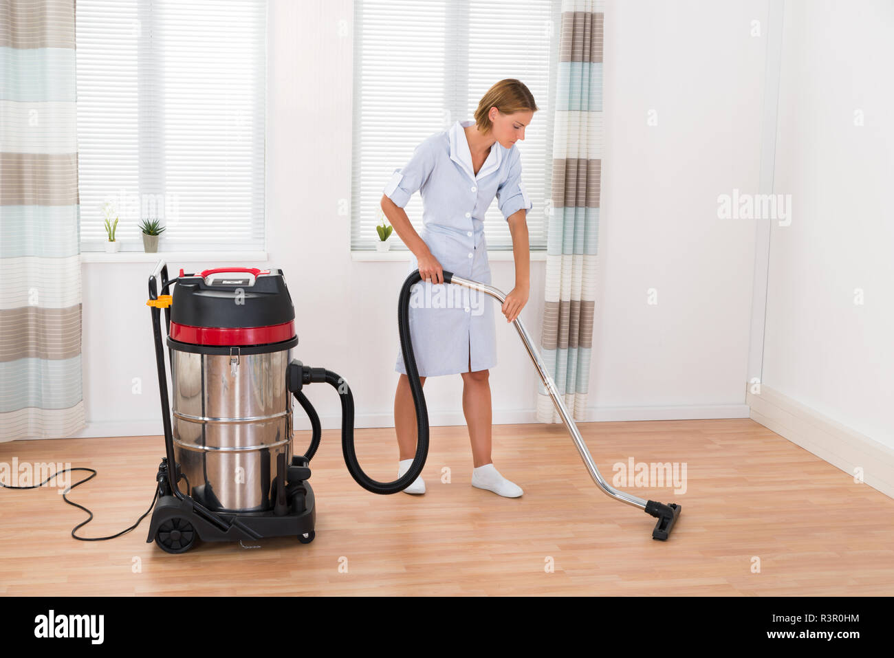 Female Maid With Vacuum Cleaner Stock Photo - Alamy