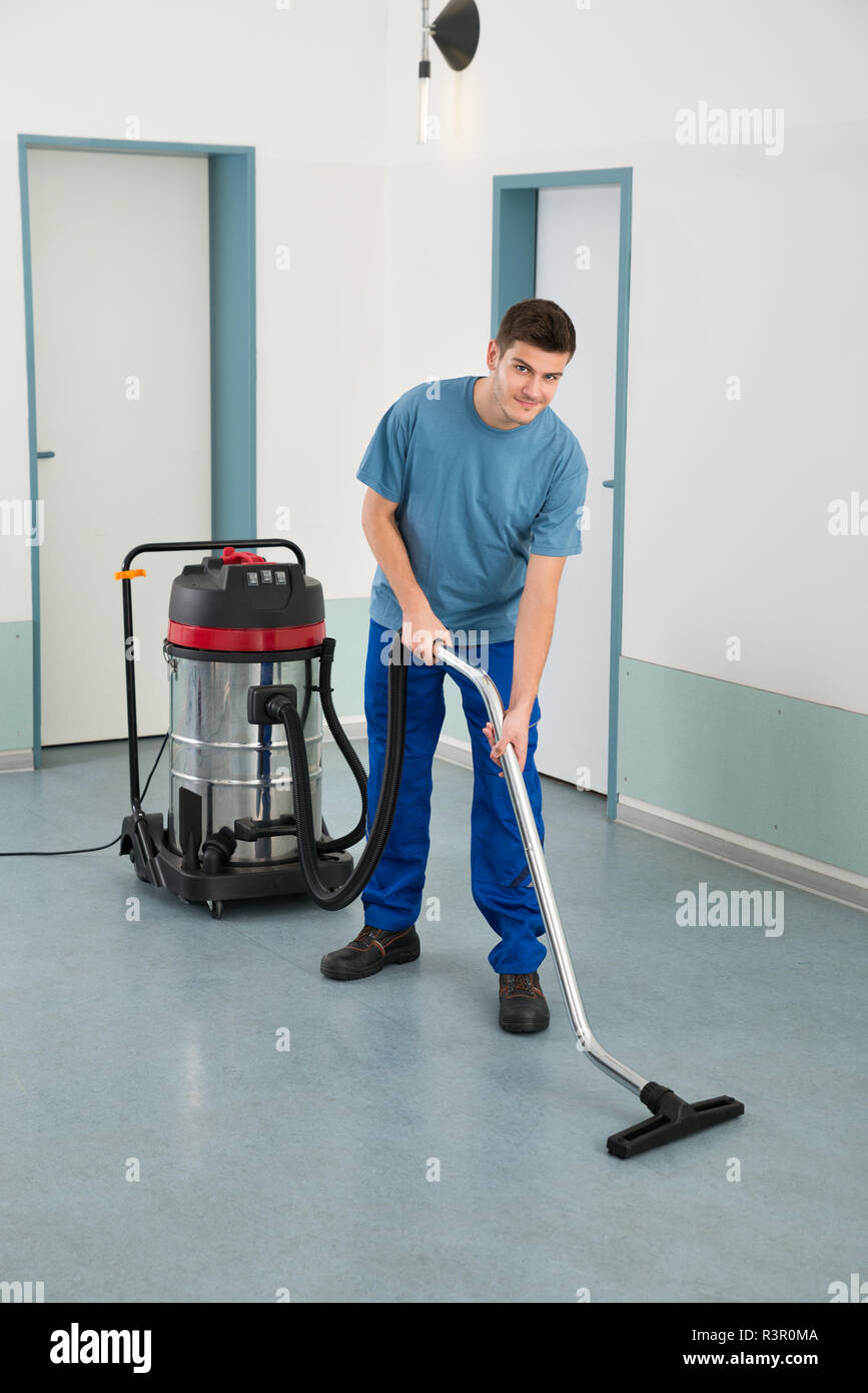 Male Worker With Vacuum Cleaner Stock Photo - Alamy