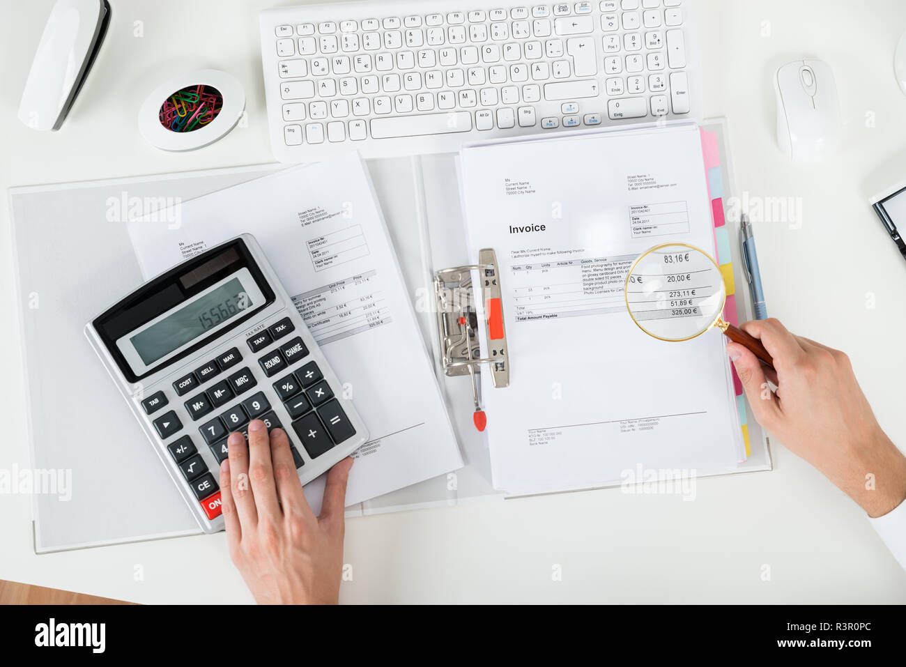 Businessperson Examining Invoice With Magnifying Glass Stock Photo - Alamy