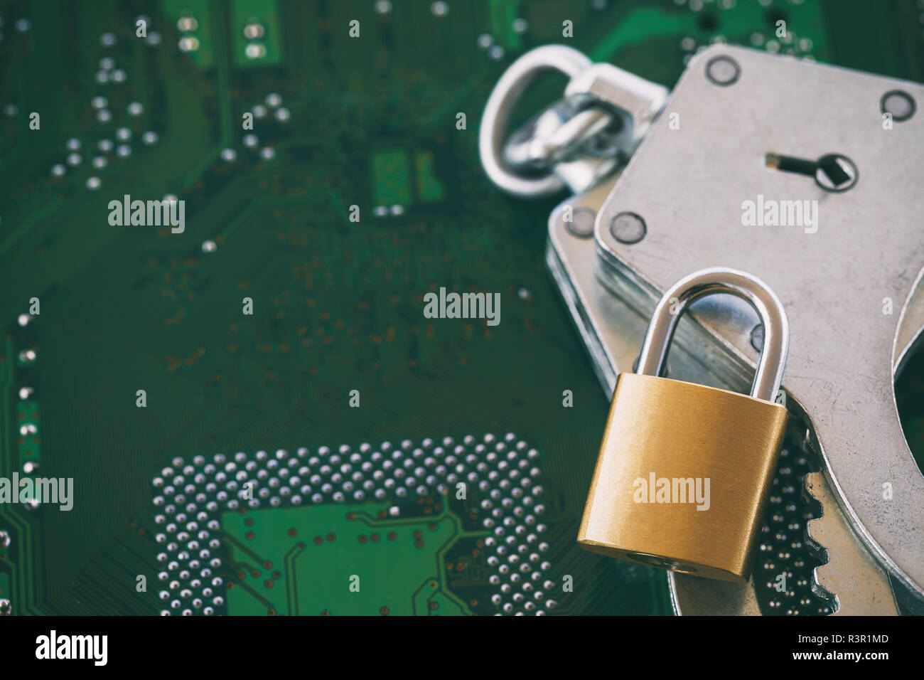 Digital security concept: Closed lock with handcuffs on the background ...