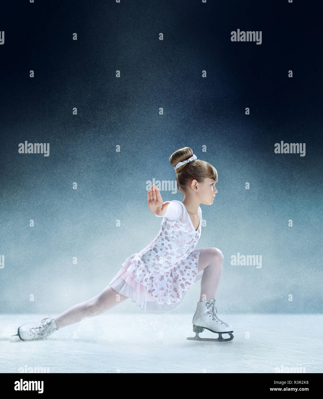 Little girl figure skating at the indoor ice arena. The dance, sport ...