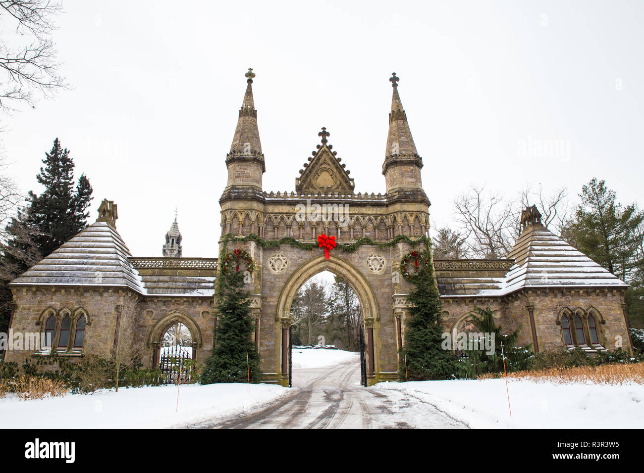 Old vintage cemetery gates architecture with snow and Christmas wreath ...