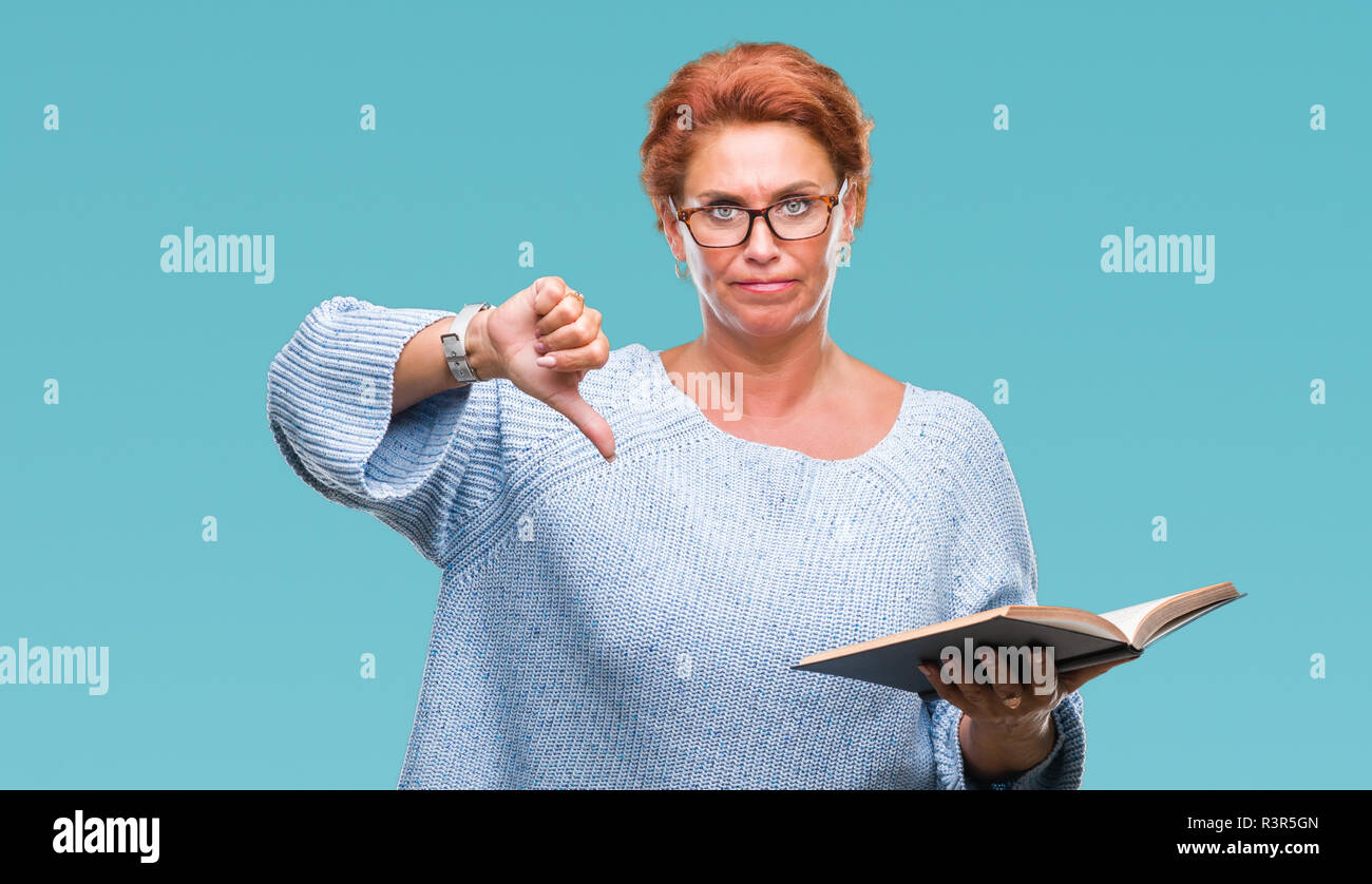 Senior caucasian woman reading a book over isolated background with ...