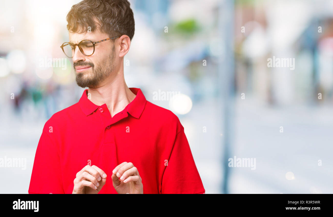 Young handsome man wearing glasses over isolated background disgusted ...