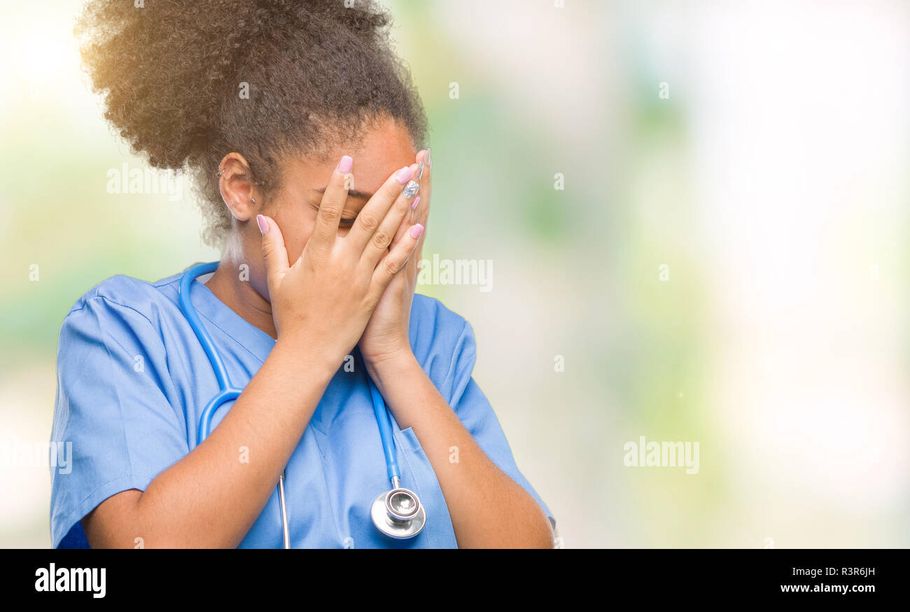 Young afro american doctor woman over isolated background with sad ...