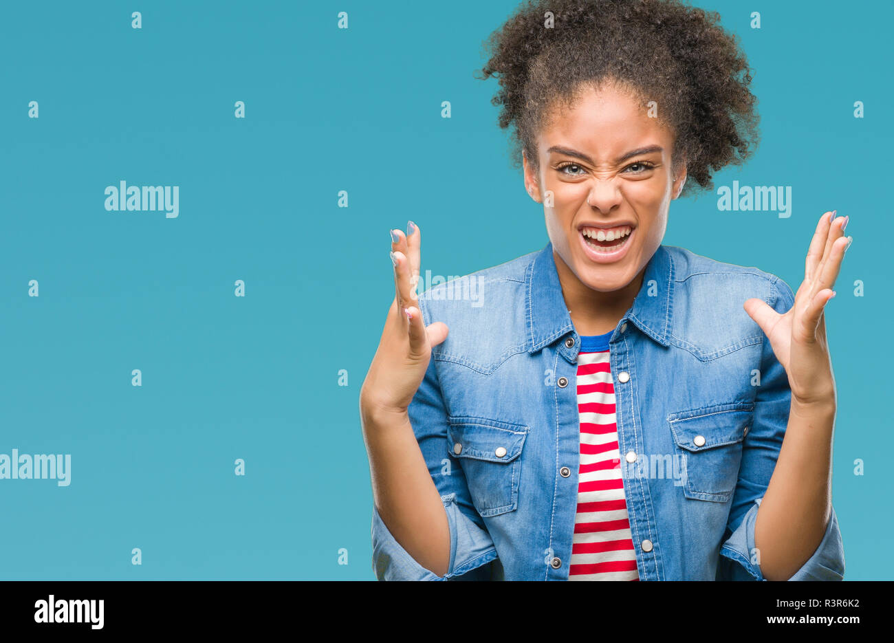 Young afro american woman over isolated background crazy and mad ...