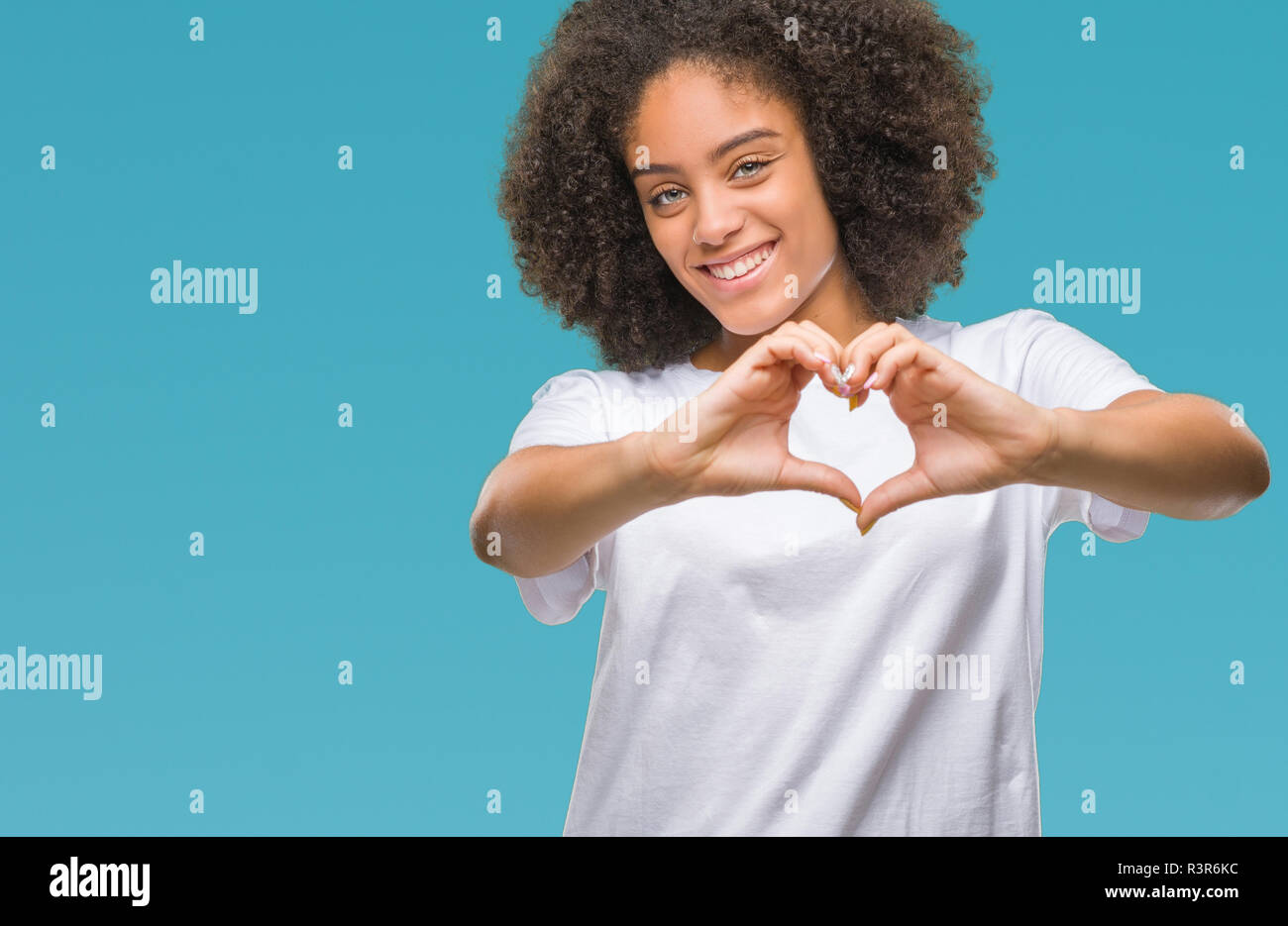 Young afro american woman over isolated background smiling in love ...