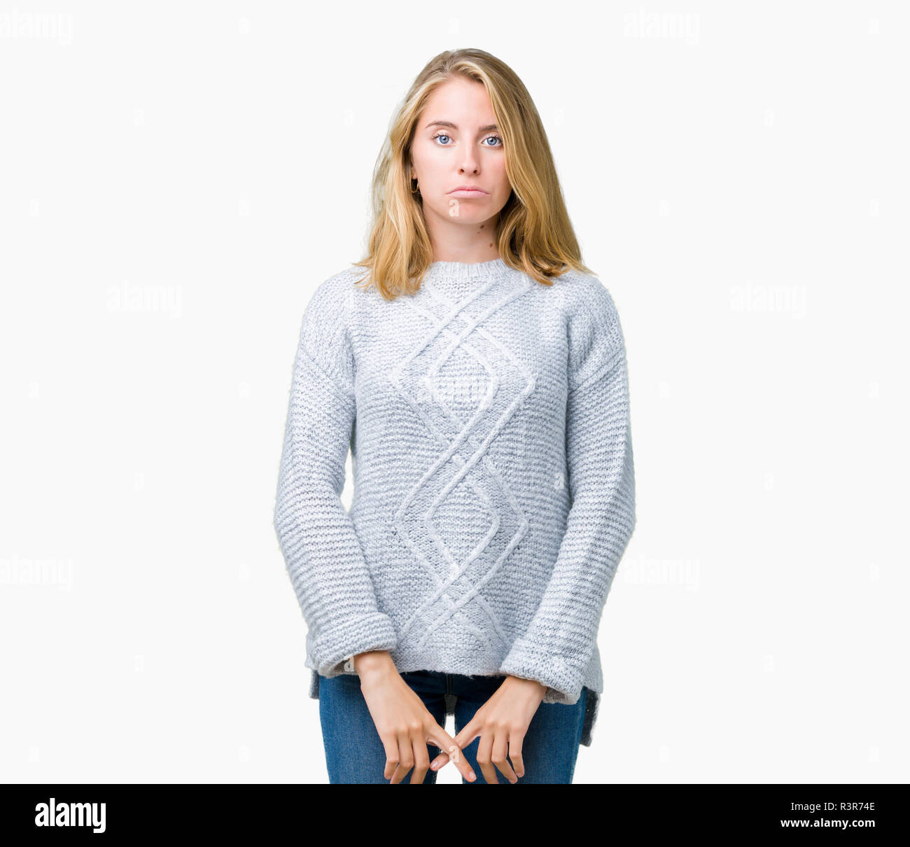 Beautiful young woman wearing winter sweater over isolated background ...