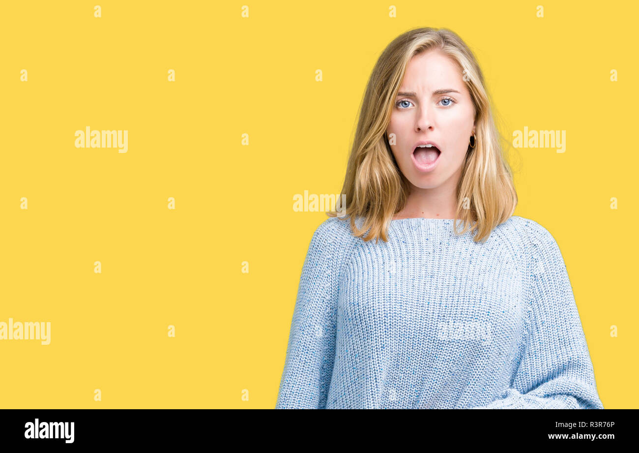 Beautiful young woman wearing blue sweater over isolated background In ...