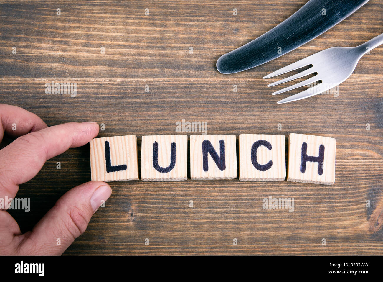 Lunch. Wooden letters on the office desk, informative and communication ...