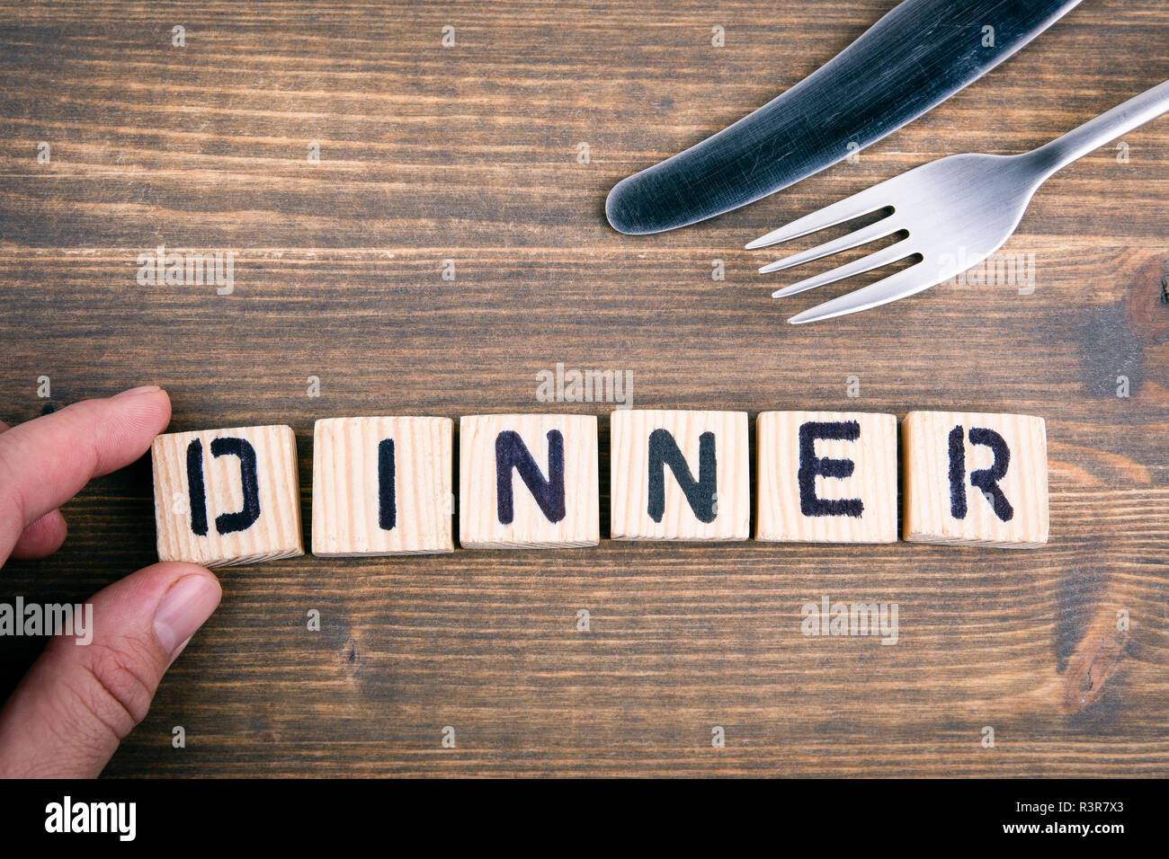 Dinner. Wooden letters on the office desk, informative and ...