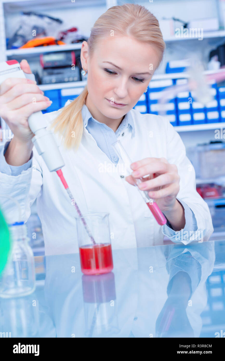 Laboratory assistant pipetting liquid into test tube Stock Photo - Alamy