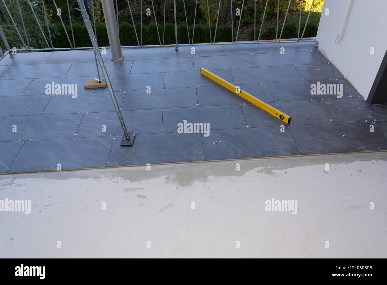 Balcony floor tiles installation. Laying tiles from porcelain. Interior ...