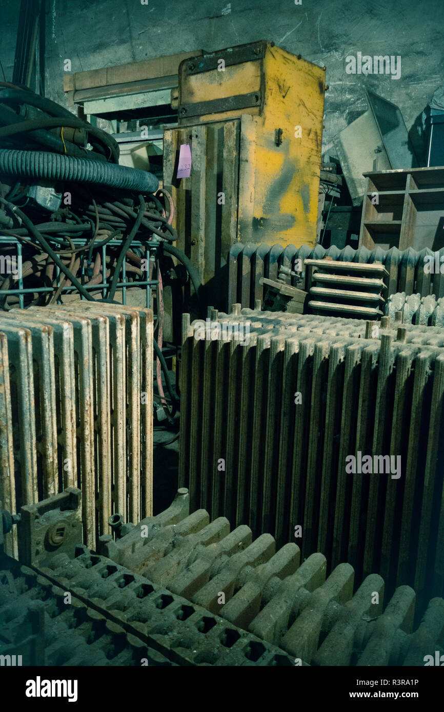 Old radiators and heating units are collected together in a warehouse ...