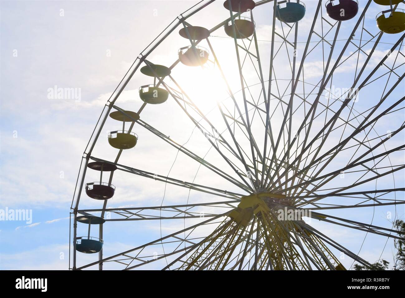 Big Ferris wheel with colorful cars in a bright sky Stock Photo - Alamy