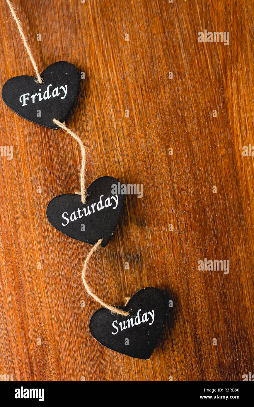 Heart of black wood with days of the weekend written on it Stock Photo ...