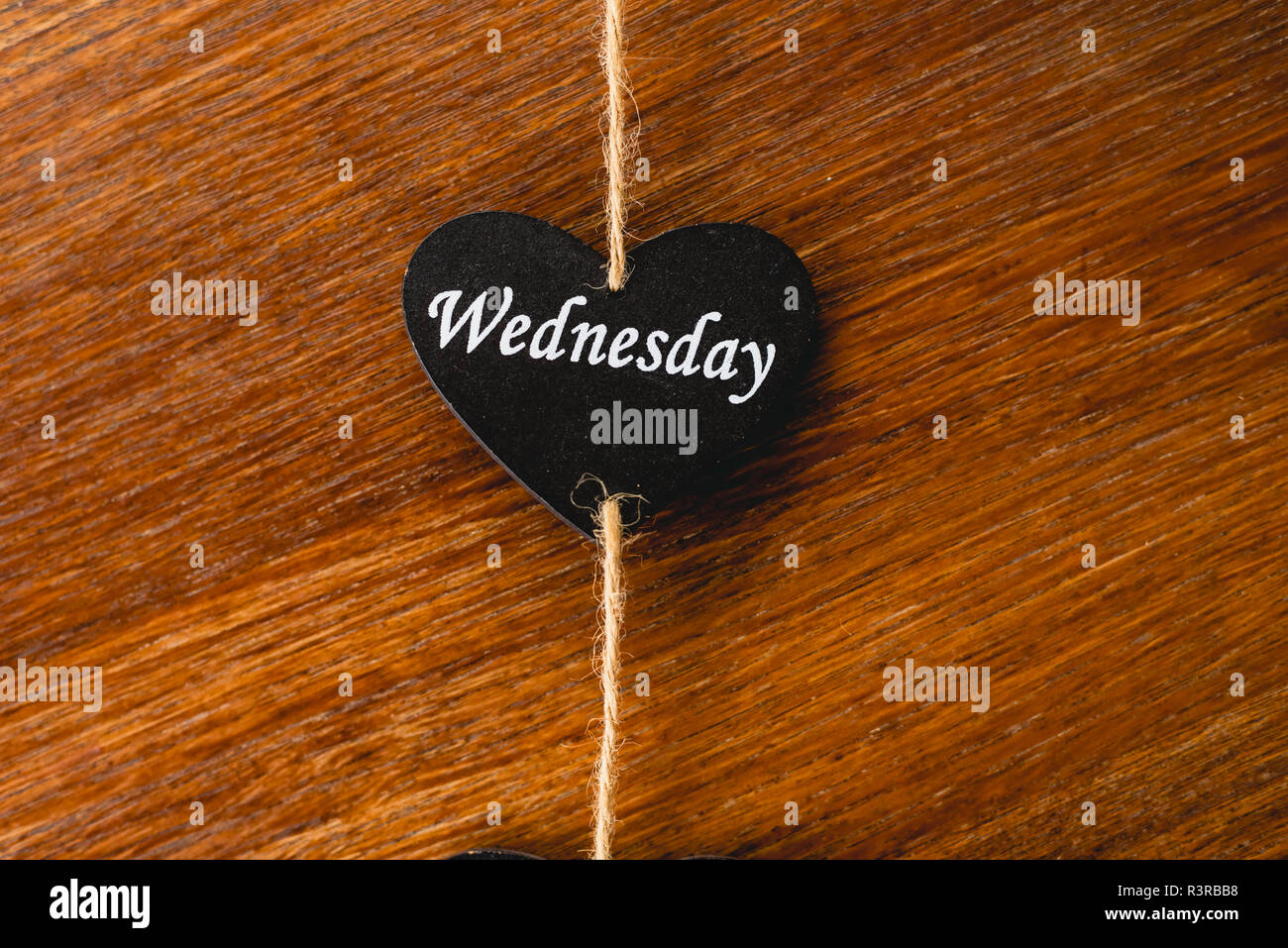 Heart of black wood with day of the week written on it, wednesday Stock ...