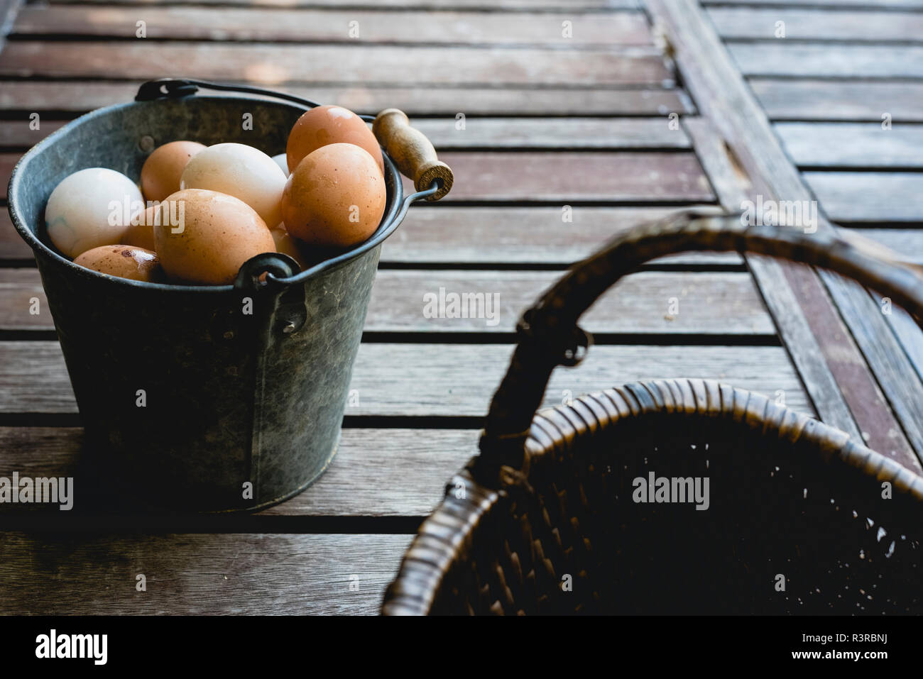 Bucket full of chicken eggs and wicker basket Stock Photo - Alamy