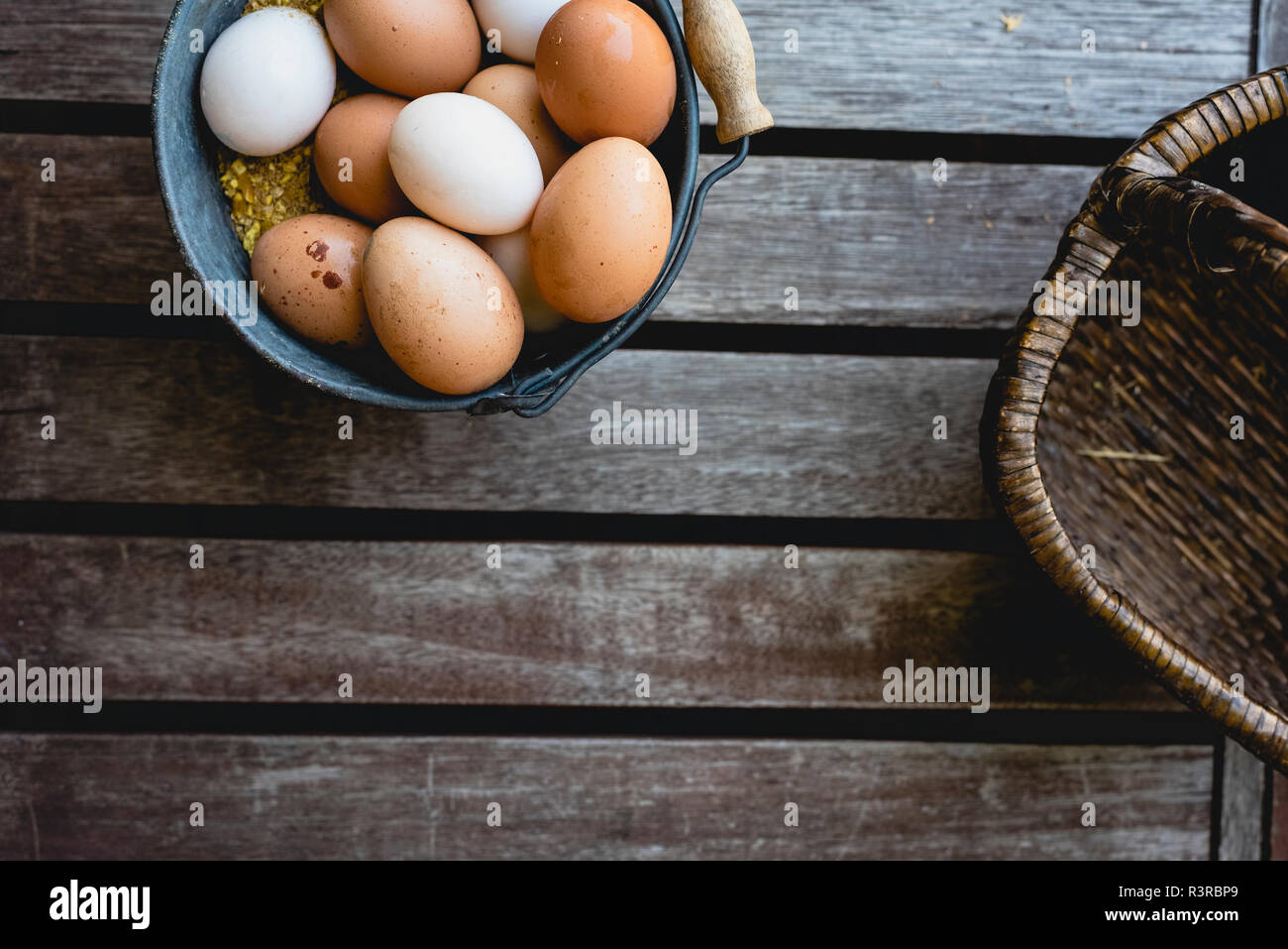Bucket full of chicken eggs and wicker basket Stock Photo - Alamy