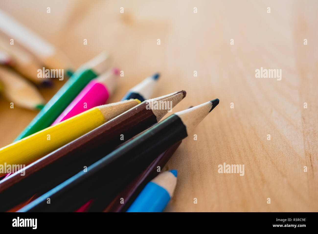 Colored pencils on a table with space for text Stock Photo - Alamy