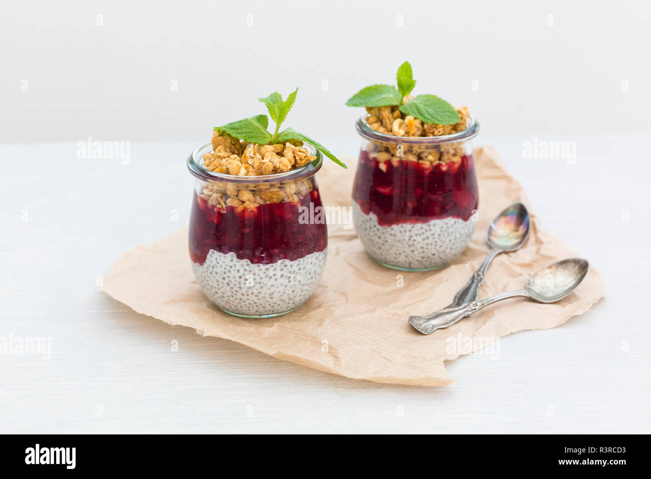Two glasses of chia pudding with coconut milk, red fruit jelly and ...