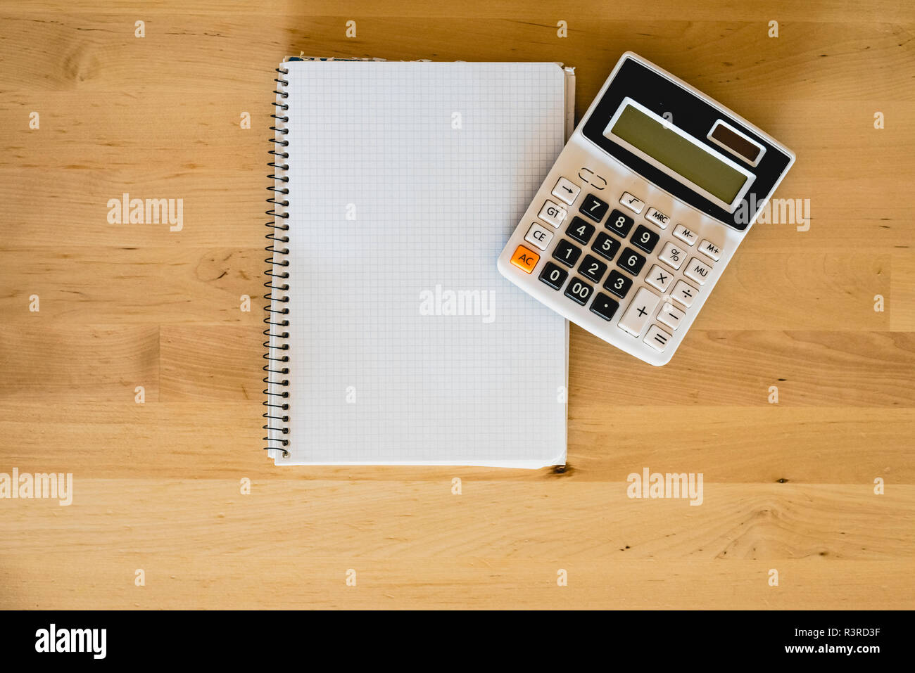Calculator and pad to calculate business expenses Stock Photo - Alamy