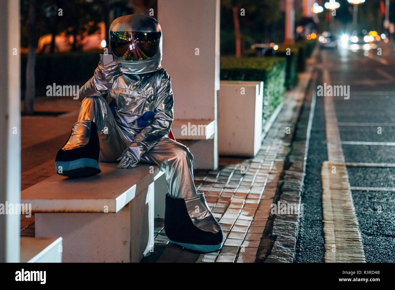 Sitting on bus stop bench hi-res stock photography and images - Alamy