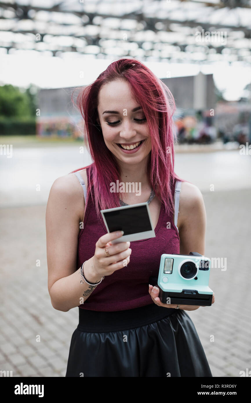 Happy young woman instant camera photo outdoors hi-res stock ...