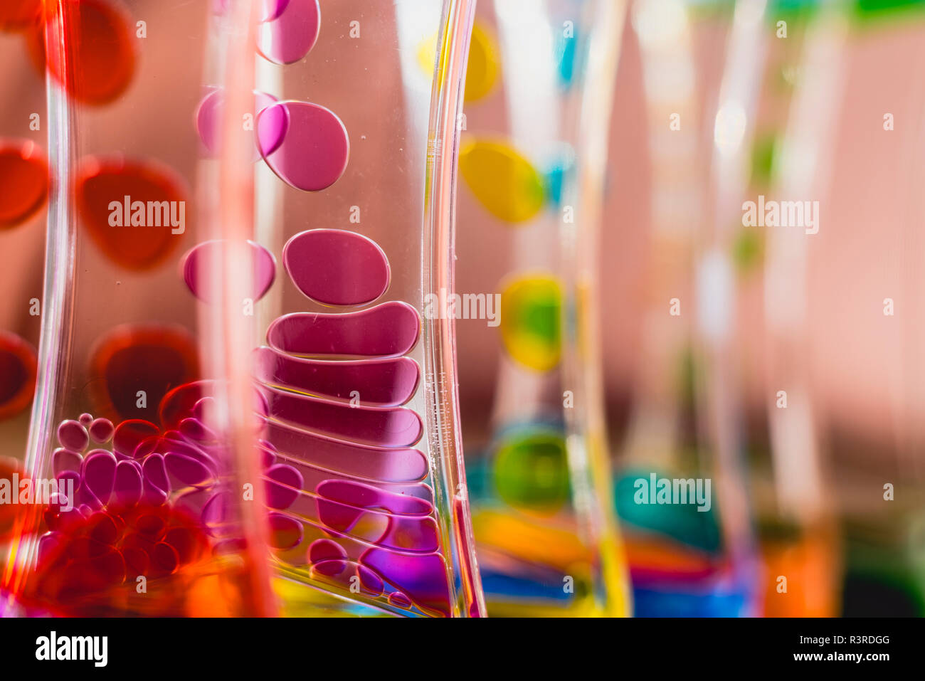 Toy with water and drops of oil colors Stock Photo - Alamy