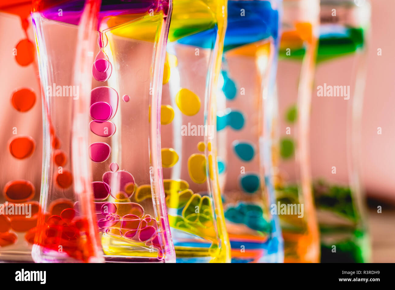 Toy with water and drops of oil colors Stock Photo - Alamy